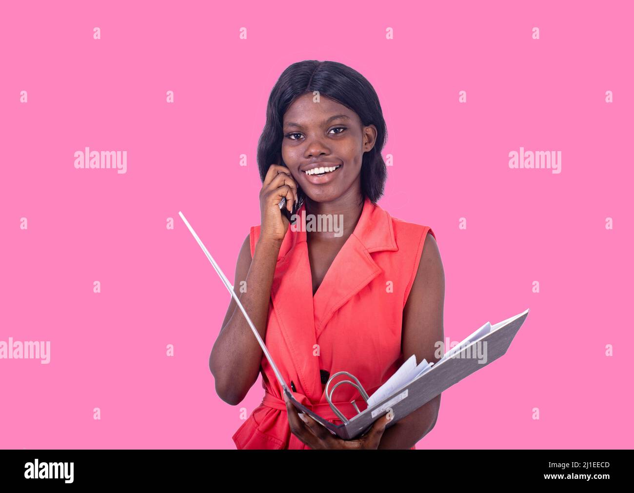 a beautiful young businesswoman in jacket standing on white background ...