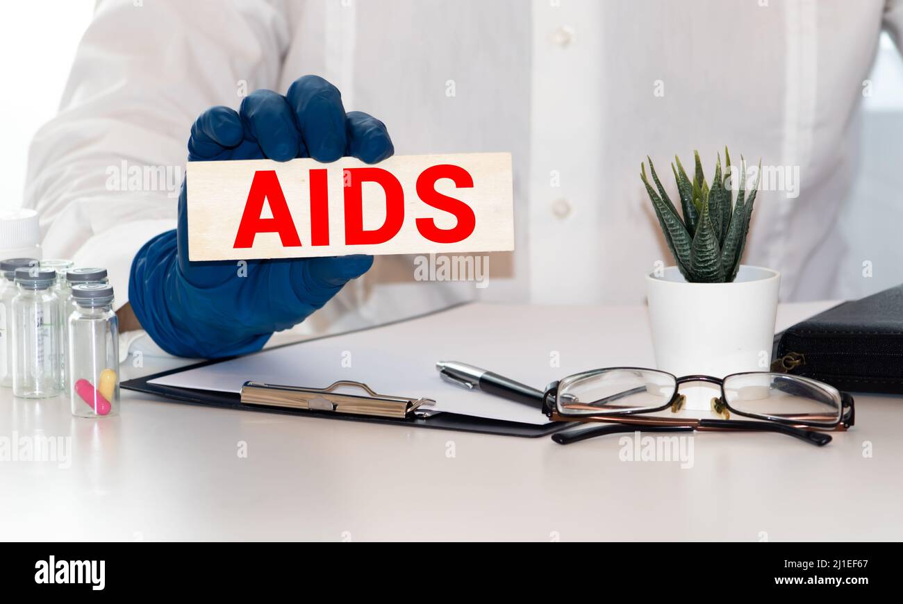 Words first aid written on white sticker held by a doctor in medical ...