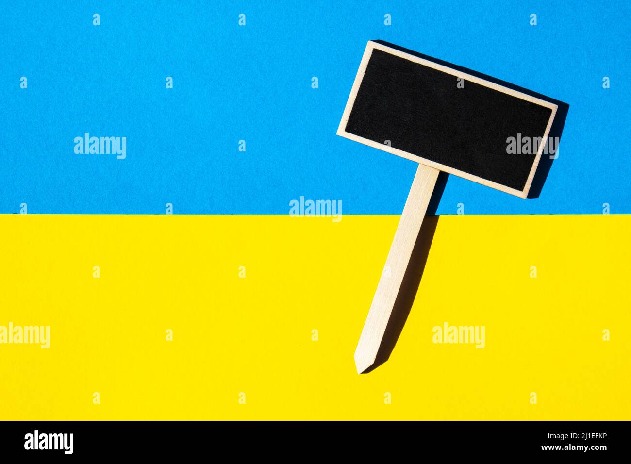 Wooden information label sign with black chalkboard against Ukrainian ...