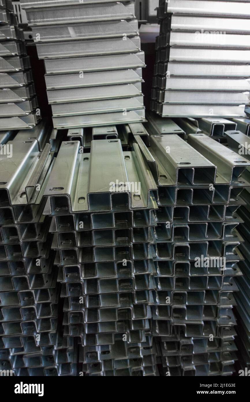 full frame view on stacks of profile bent sheet metal parts Stock Photo ...