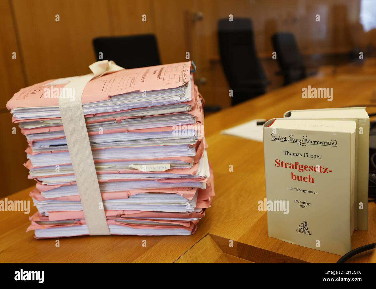 Aachen, Germany. 25th Mar, 2022. Files and a copy of the penal code lie ...