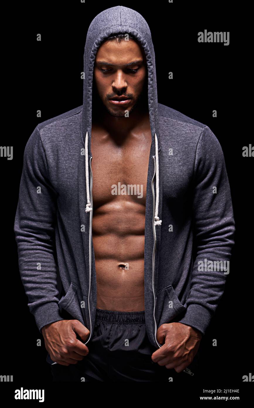 Getting his fitness on. Studio shot of a muscular young man wearing a ...