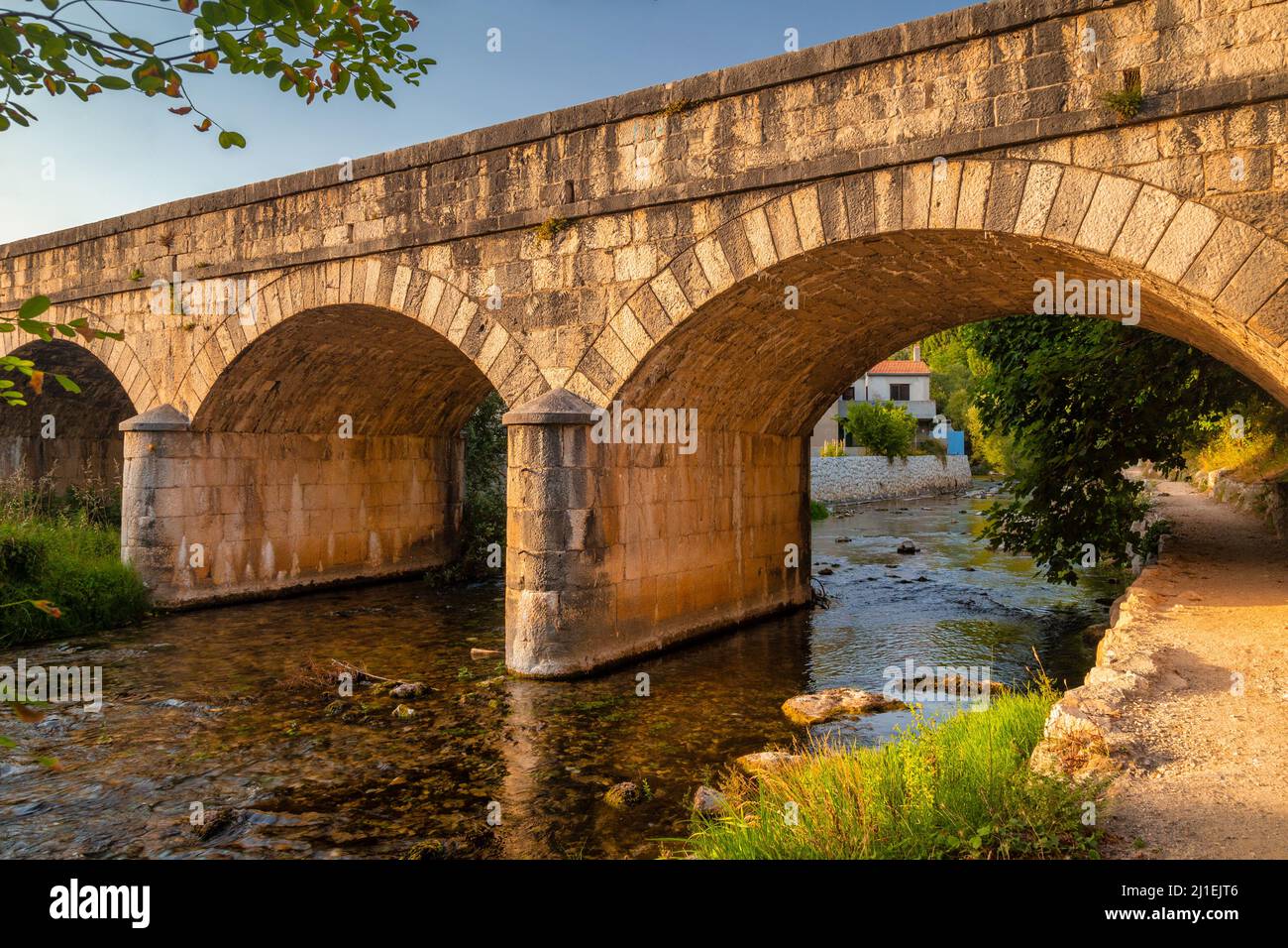 Stone bridge on the lower reaches of the river Zrnovnica, near Split ...
