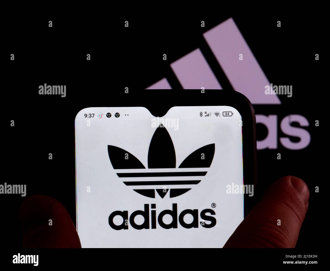 In this photo illustration, the Adidas logo is displayed on a ...