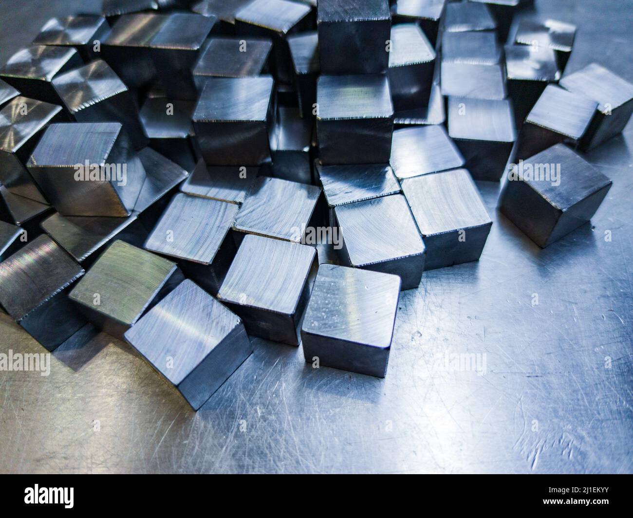 pile of small machined shiny steel cubes on metal surface Stock Photo ...