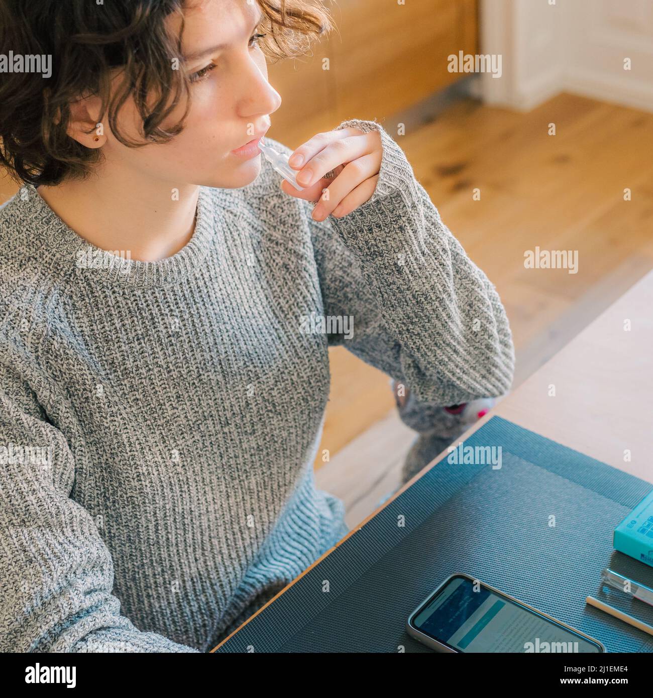 Collection of saliva test for coronavirus at home. teenage girl is ...