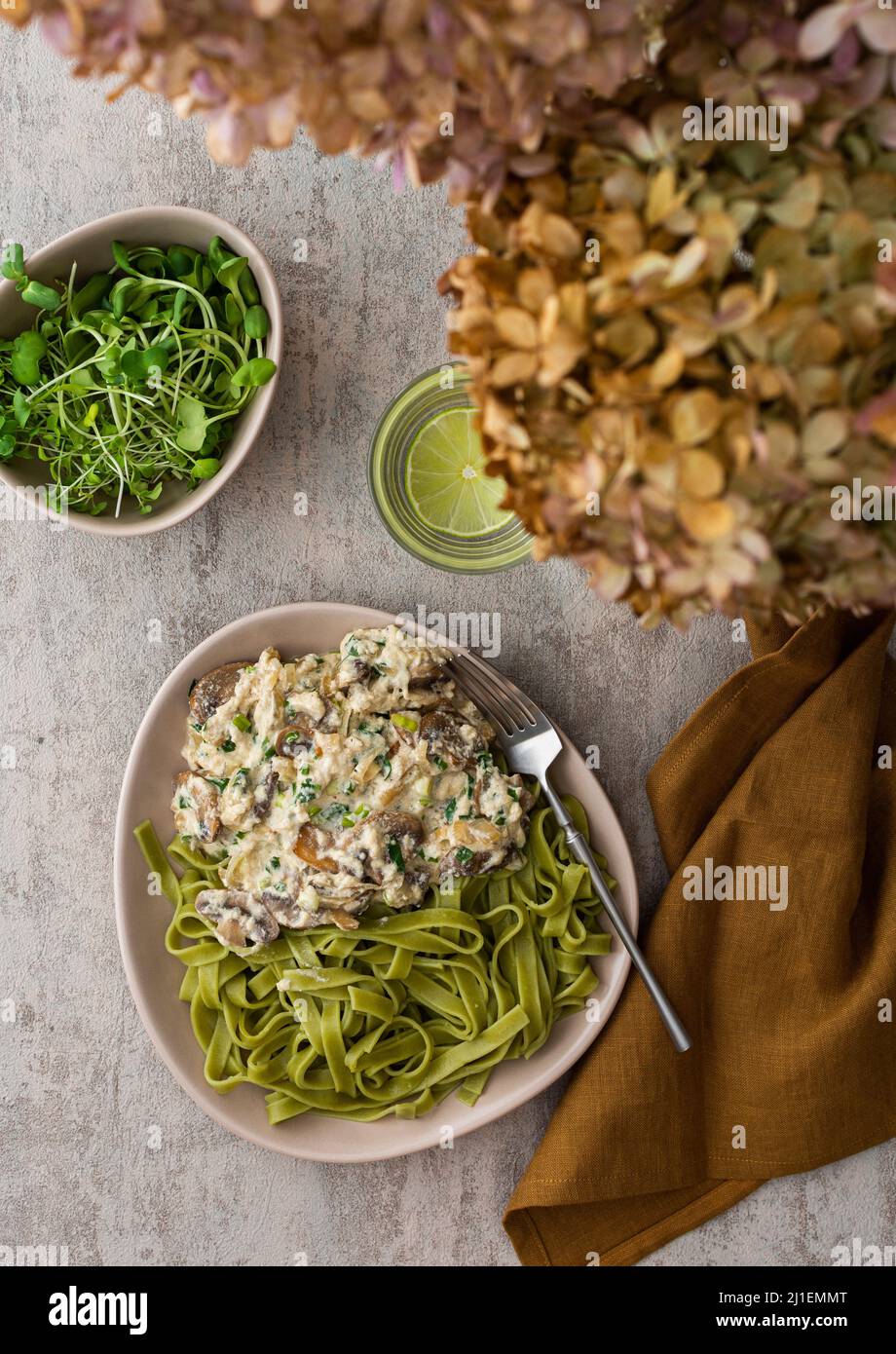 Green pasta from durum wheat and gravy with champignons fried in sour ...