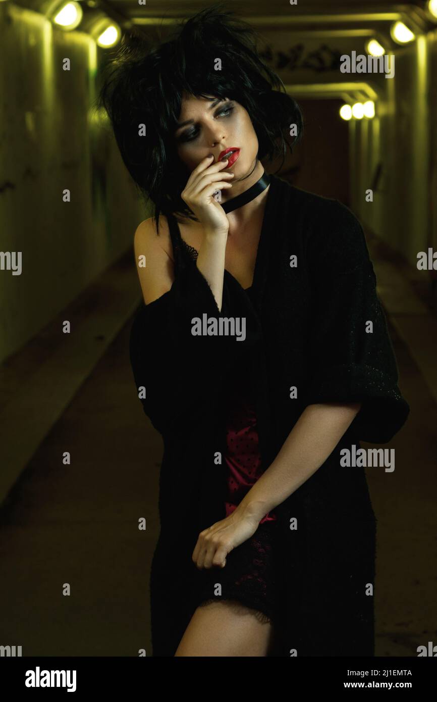 Strange and freaky woman in the dark tunnel Stock Photo - Alamy