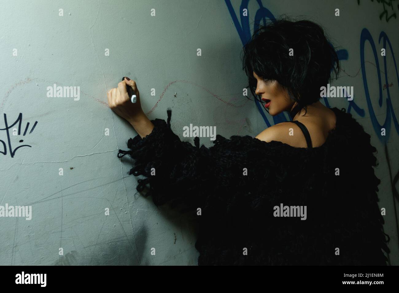 Freaky woman in dark tunnel with graffiti Stock Photo - Alamy