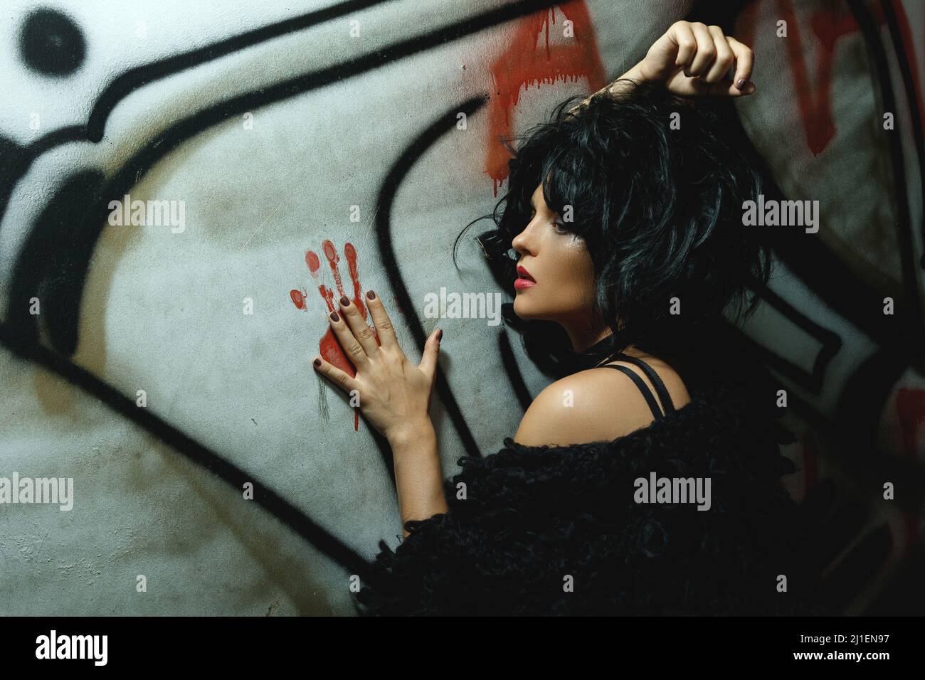 Freaky woman in dark tunnel with graffiti Stock Photo - Alamy