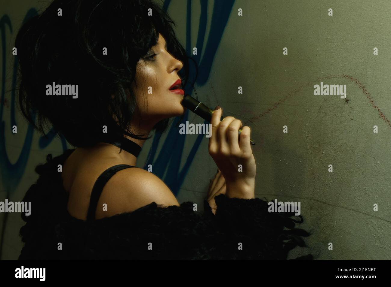 Freaky woman in dark tunnel with graffiti Stock Photo - Alamy