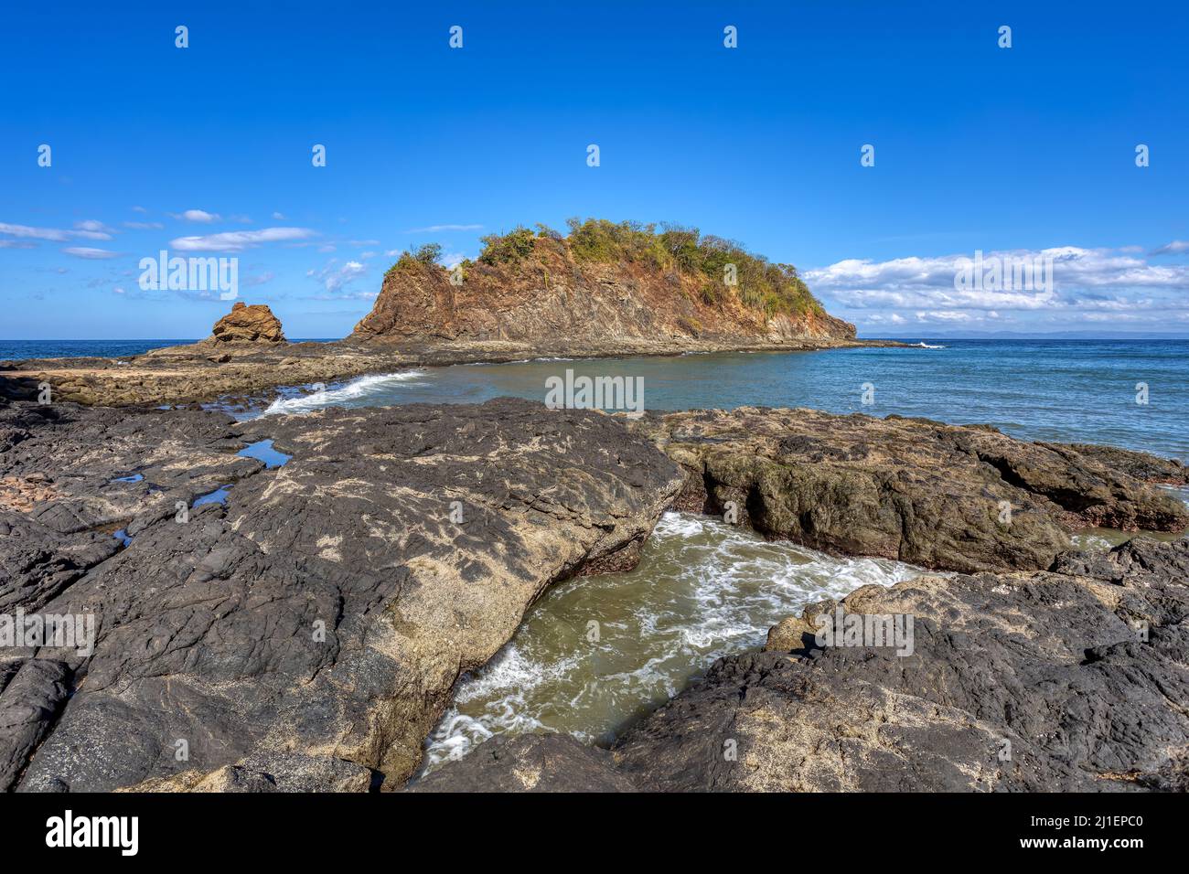Playa Ocotal with Pacific ocean waves on rocky shore, El Coco Costa ...
