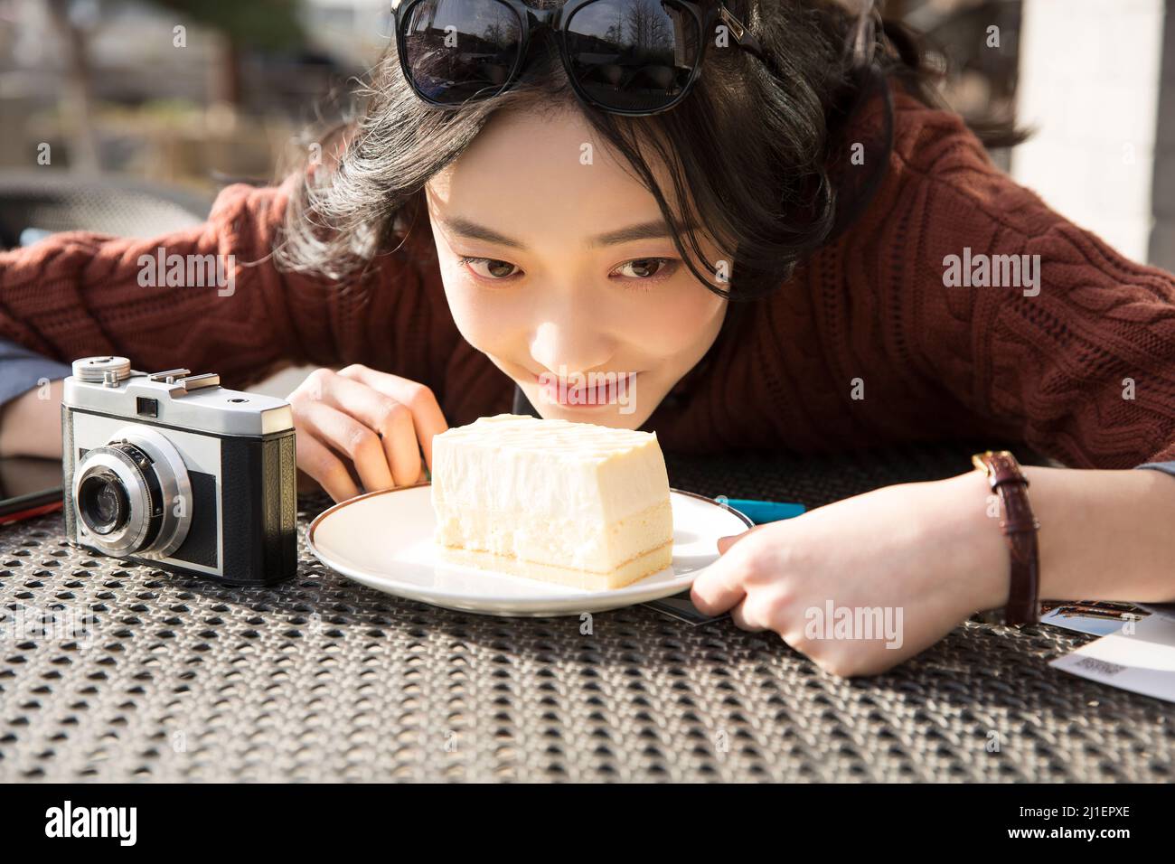 Chinese college student enjoying afternoon tea in sidewalk cafe - stock ...