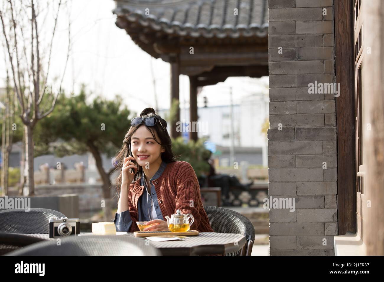 Chinese college student calling friend and enjoying afternoon tea in ...