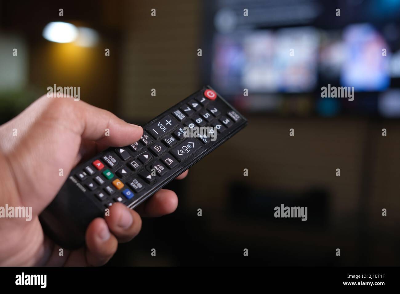 close up of man hand holding tv remote Stock Photo - Alamy