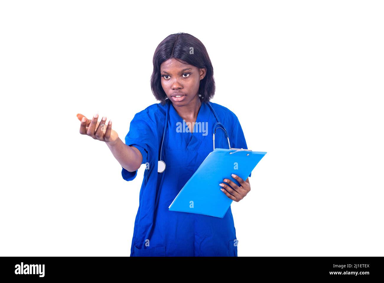 young charming nurse in lab coat standing on white background with ...