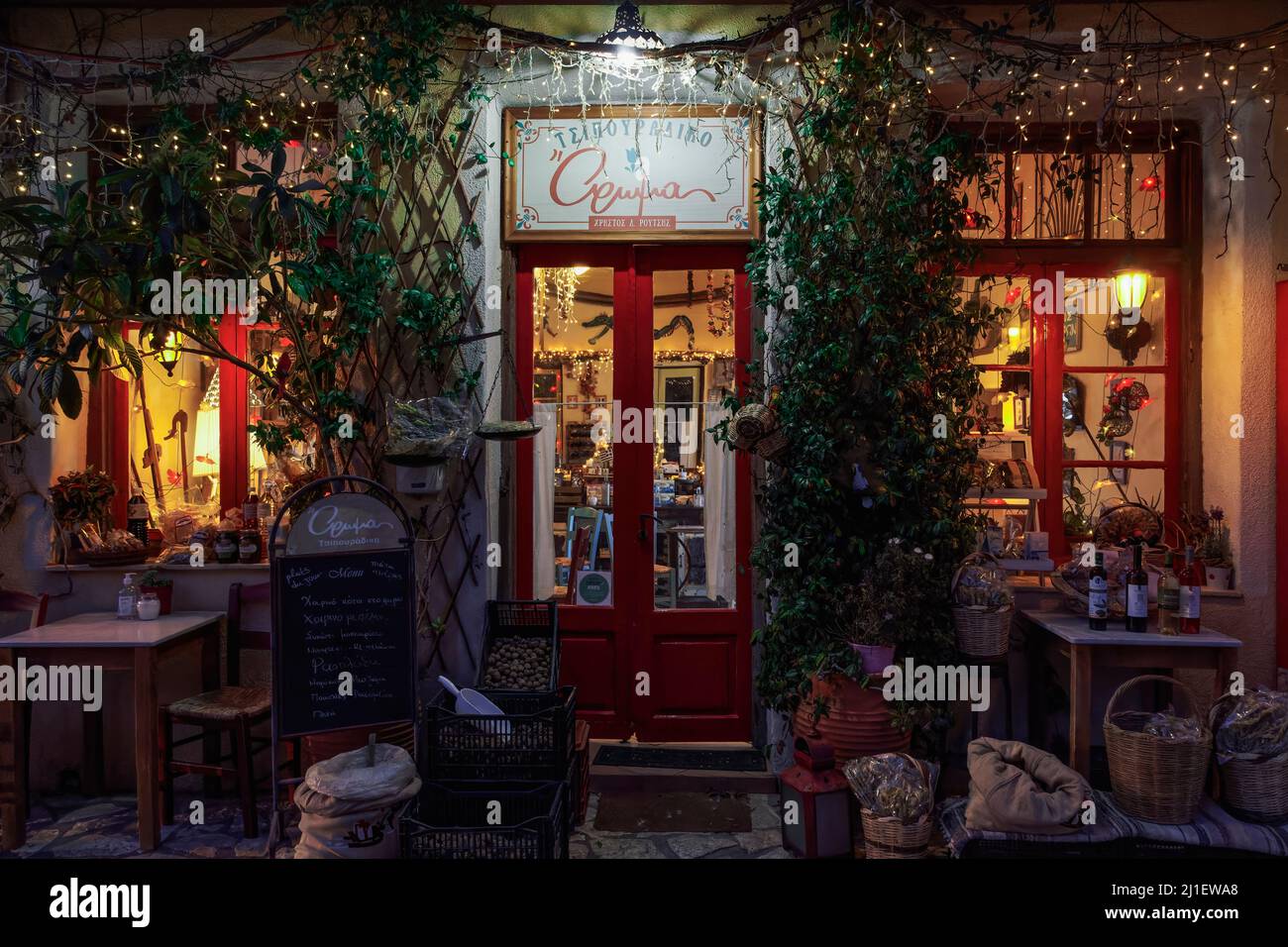 Traditional Greek tsipouro empty tavern decorated facade with sign ...
