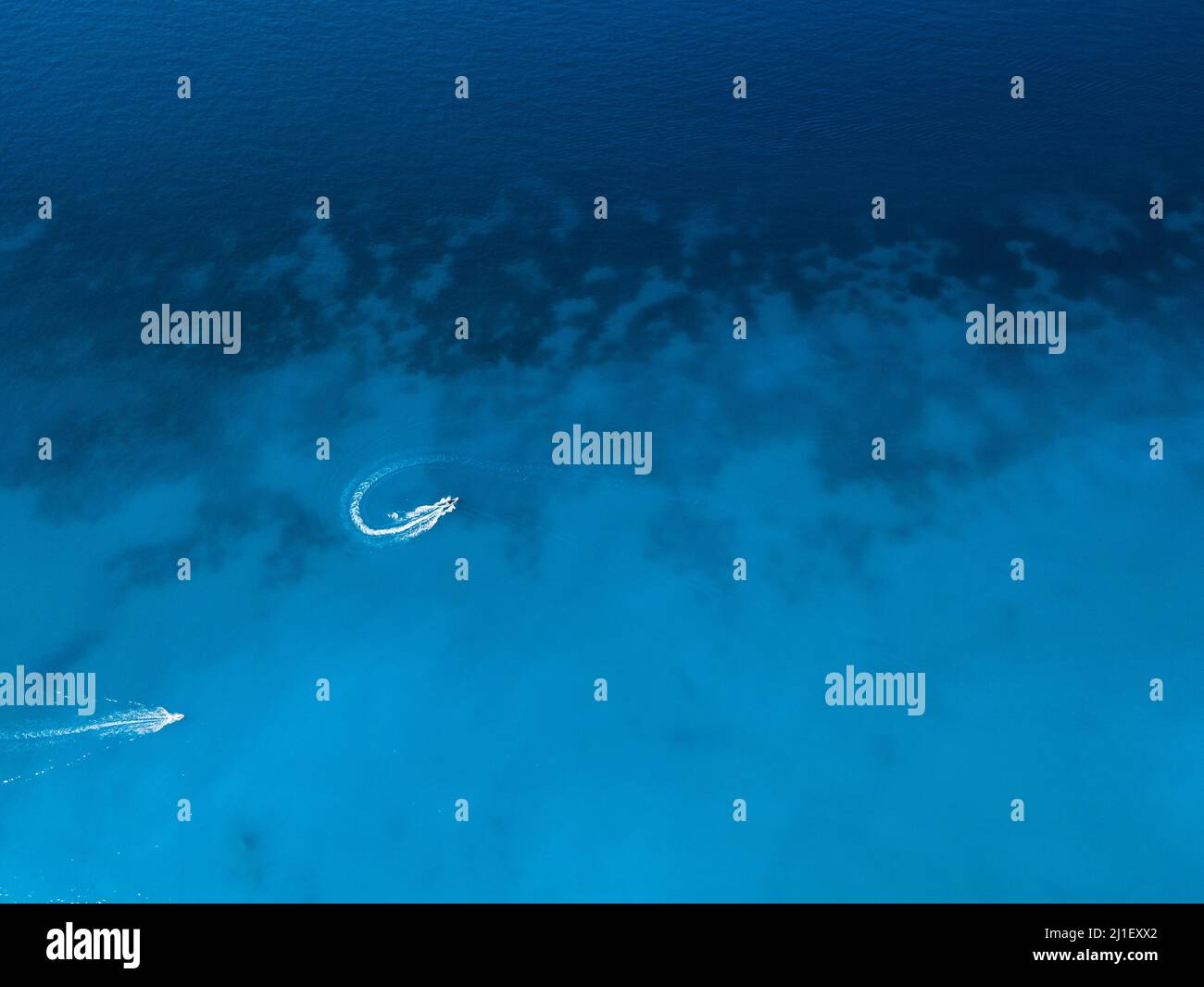 aerial view of speed boat making waves in blue sea water Stock Photo ...