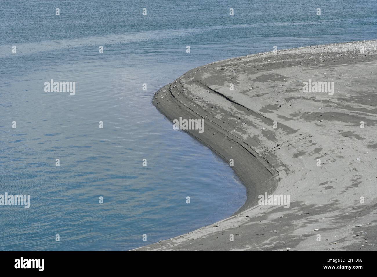 A scenic view of the blue seascape against the sandy beach on a sunny ...