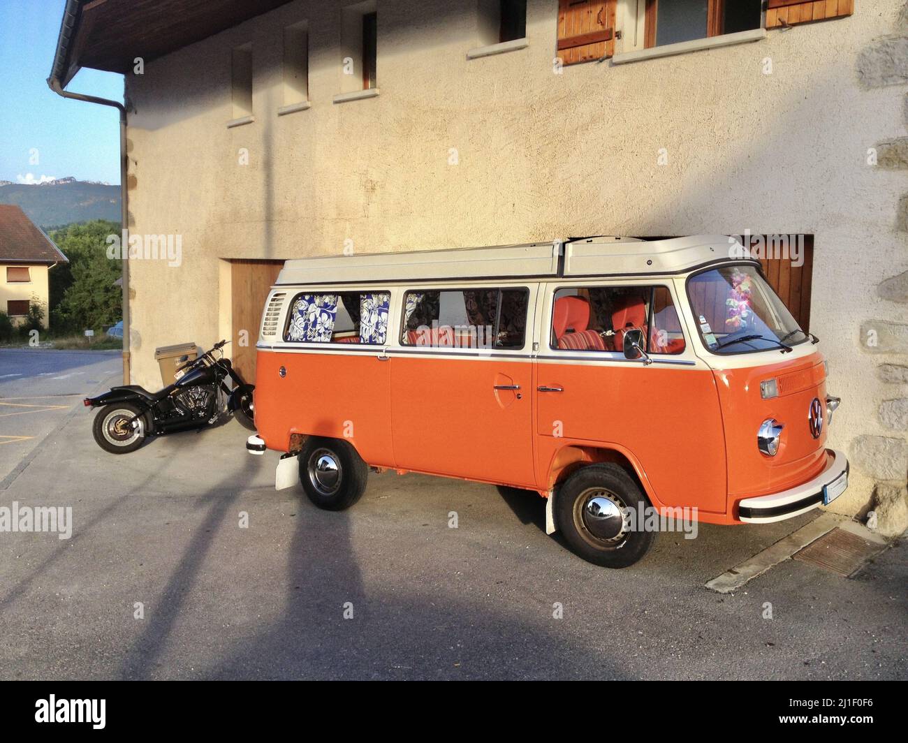 Vivid orange Volkswagen combi van vintage in a perfect condition Stock ...