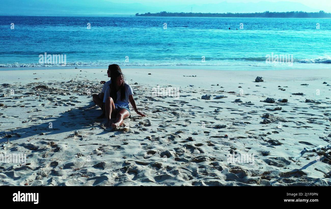 a photo of girl lying on the beach Stock Photo - Alamy