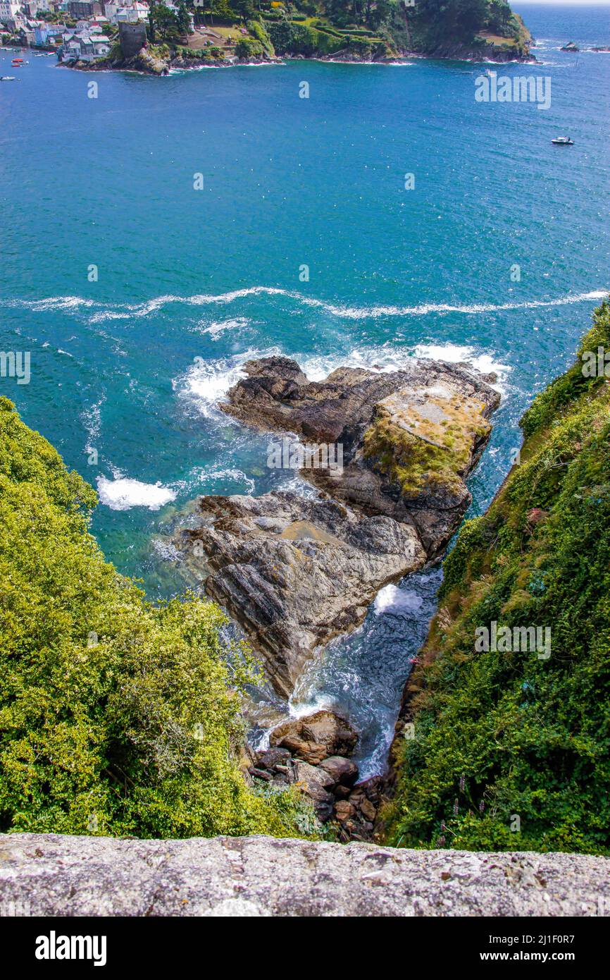 A vertical shot of the cliffy seashore in Fowey, UK Stock Photo - Alamy