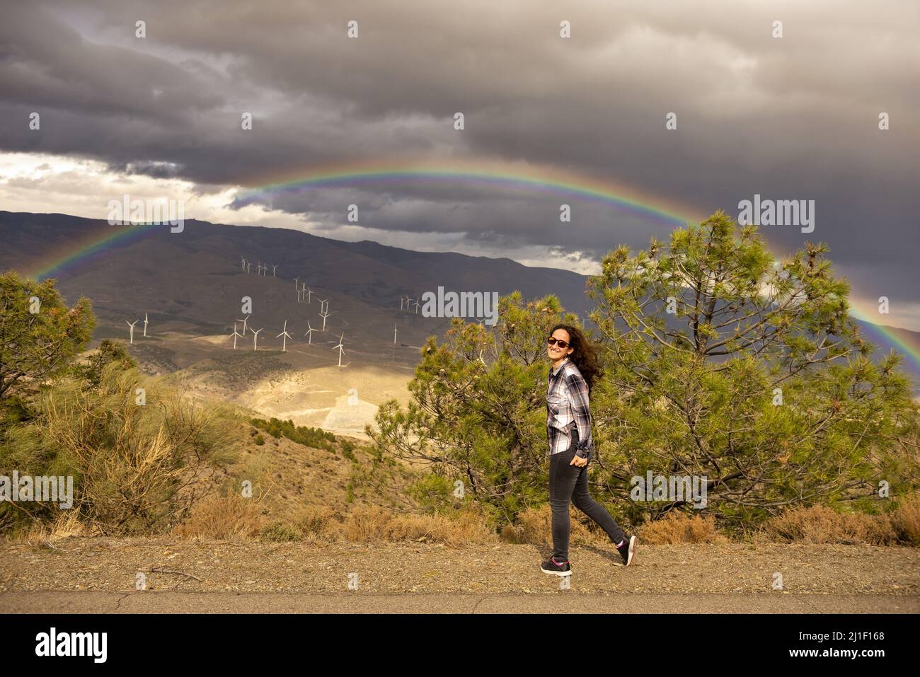 Rainbow with woman in front smiling and having fun watching him Stock ...