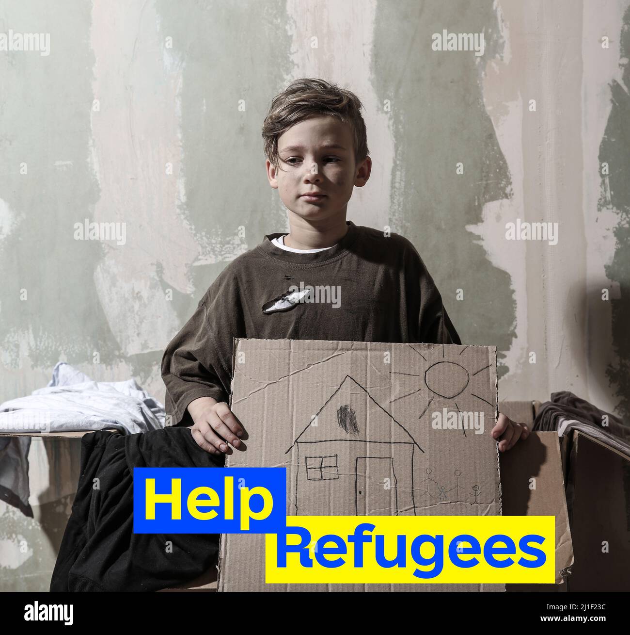Homeless little boy with picture of house on piece of cardboard. Help ...