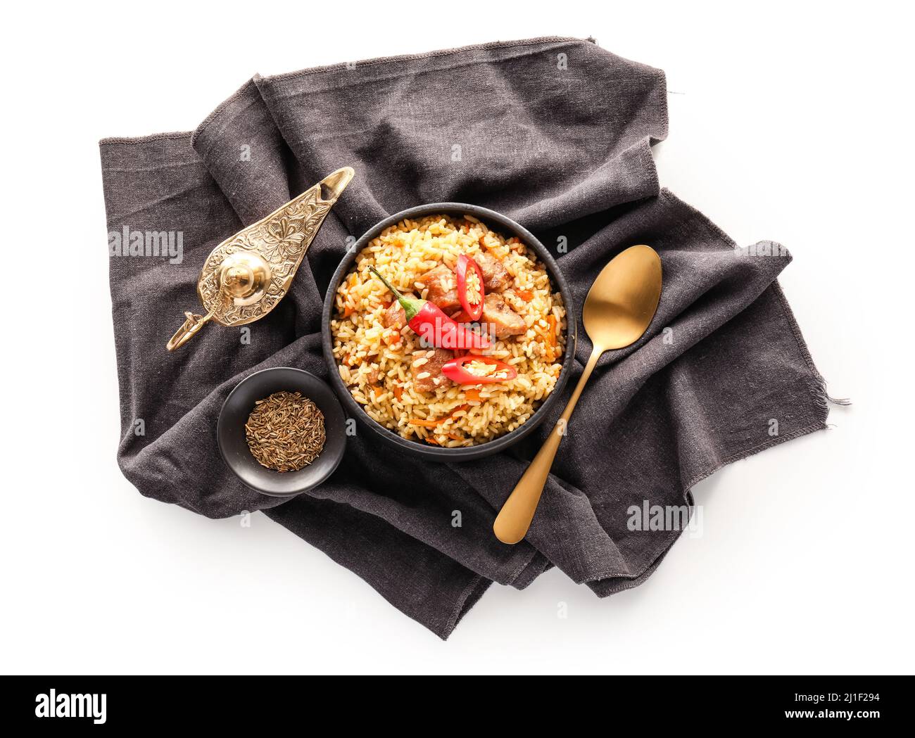 Bowl of traditional pilaf and Aladdin lamp on white background Stock ...