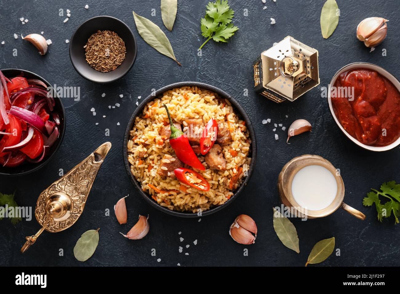 Bowl of traditional pilaf and Arabic lamps on dark background Stock ...