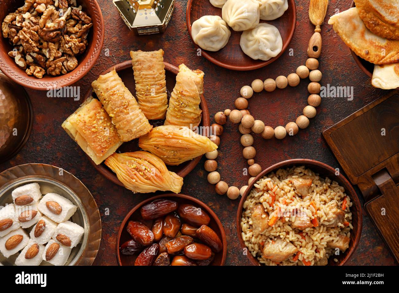 Traditional Eastern dishes with tasbih on color background Stock Photo ...
