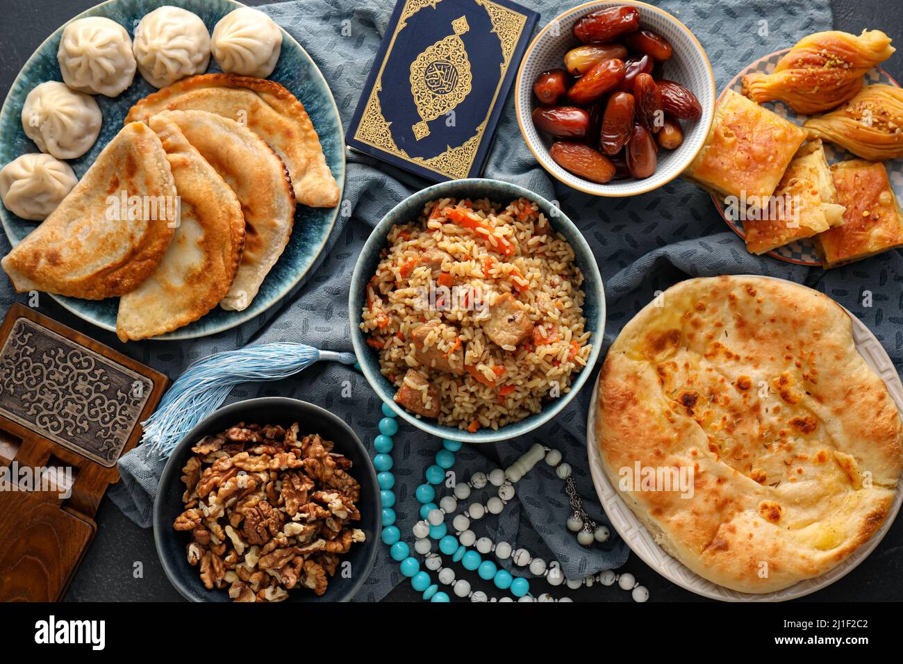 Traditional Eastern dishes with Quran on dark background Stock Photo ...