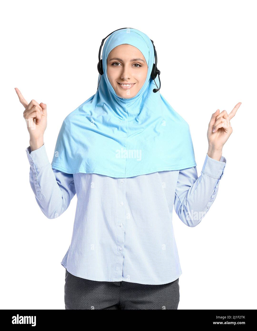 Muslim secretary with headset pointing at something on white background ...