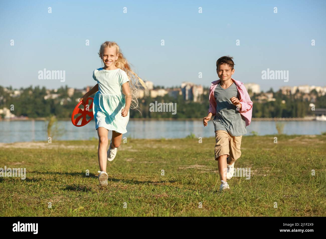Cute little children playing frisbee outdoors Stock Photo - Alamy