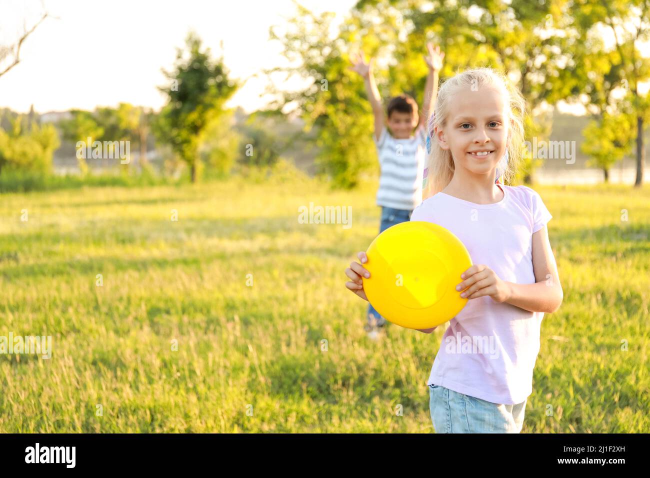 Cute little children playing frisbee outdoors Stock Photo - Alamy