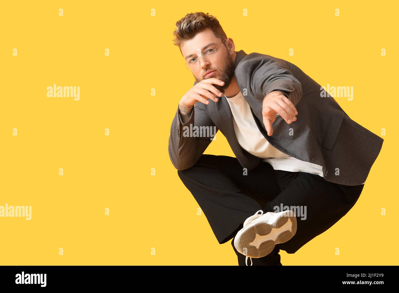 Cool dancing young man on color background Stock Photo - Alamy