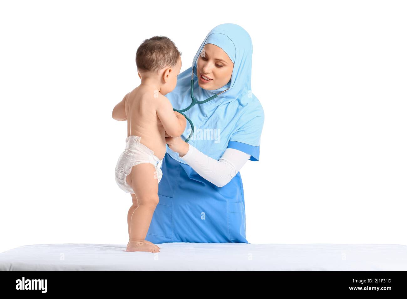 Muslim pediatrician examining baby boy on white background Stock Photo ...
