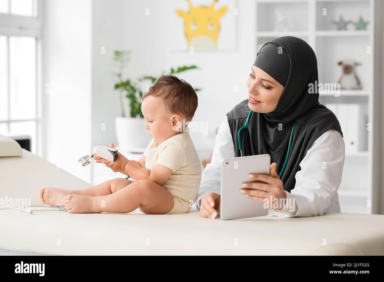 Muslim pediatrician examining baby boy in clinic Stock Photo - Alamy