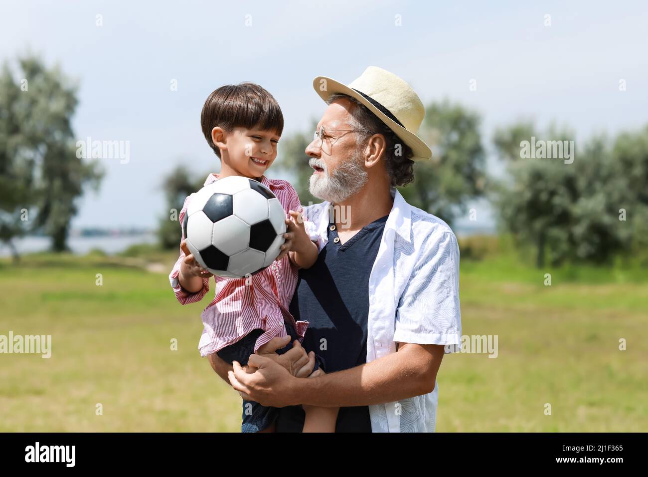 Children carrying ball hi-res stock photography and images - Alamy