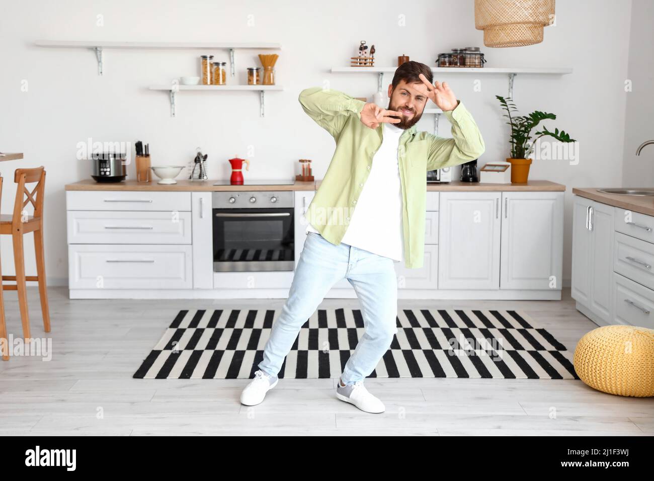 Handsome man dancing in kitchen Stock Photo - Alamy