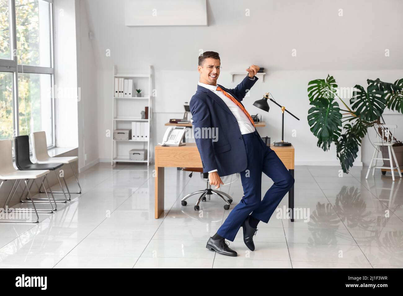 Young guy dancing in office hi-res stock photography and images - Alamy