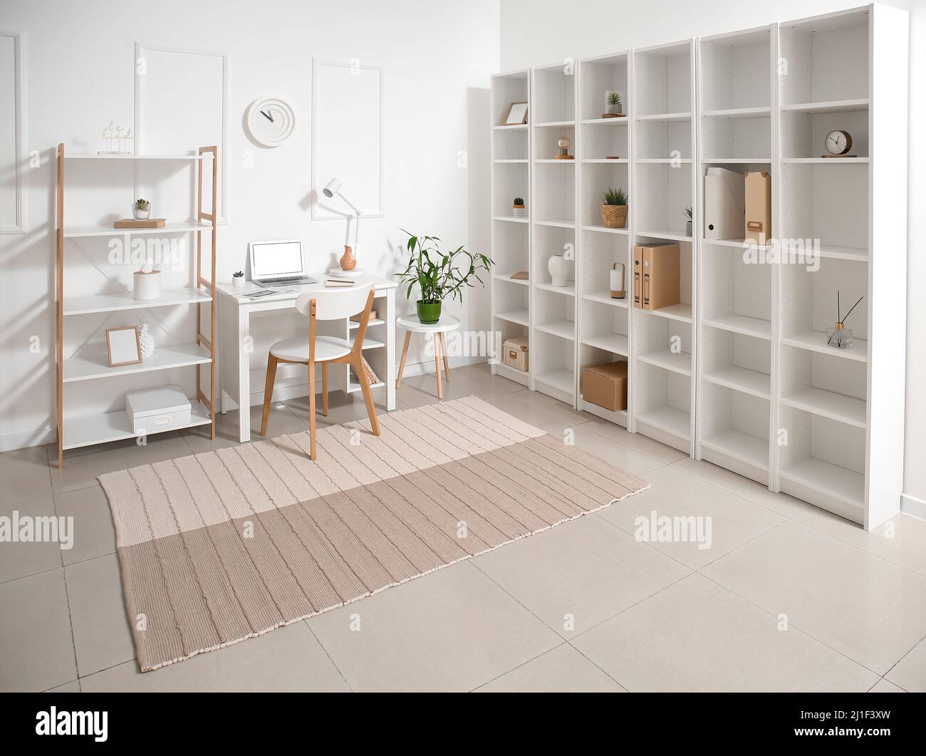 Stylish interior on room with big shelf unit and workplace Stock Photo ...
