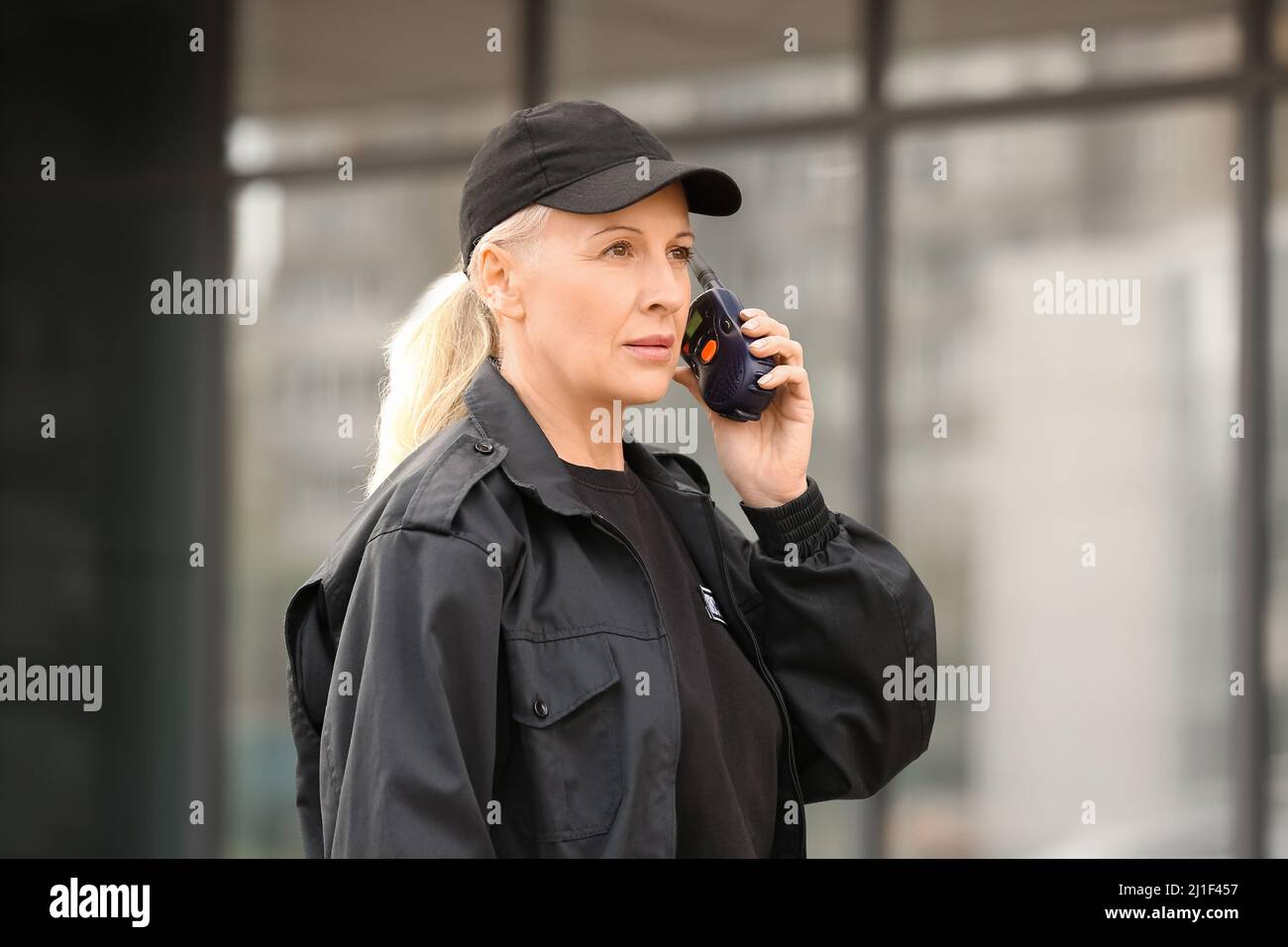 Female security guard with radio transmitter outdoors Stock Photo - Alamy