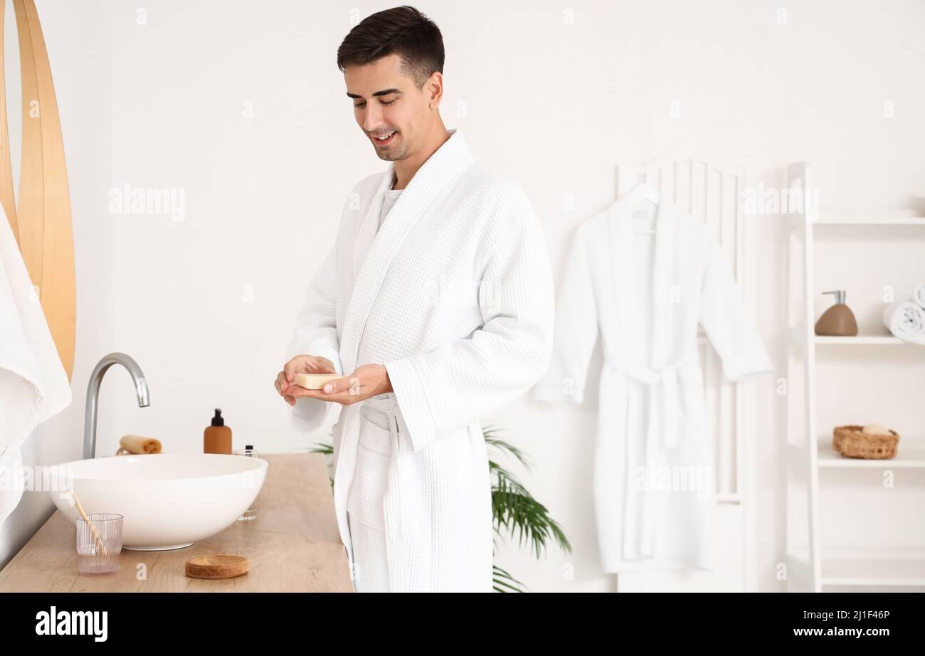 Handsome young man washing hands in bathroom Stock Photo - Alamy