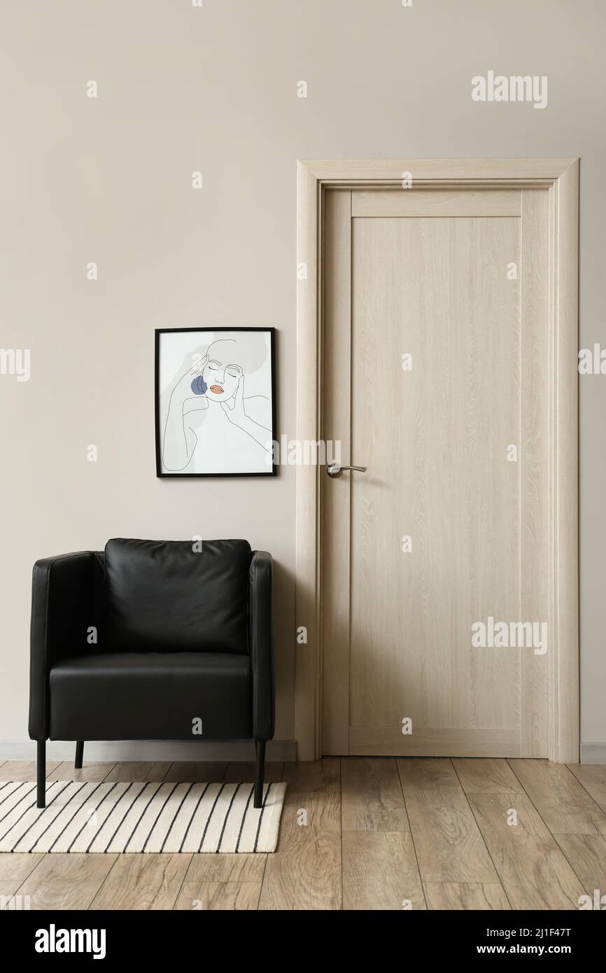 Interior of room with armchair near door Stock Photo - Alamy