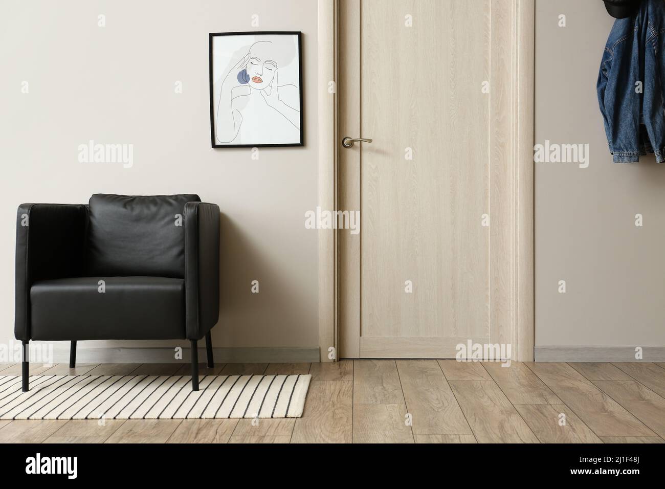 Interior of room with armchair near door Stock Photo - Alamy