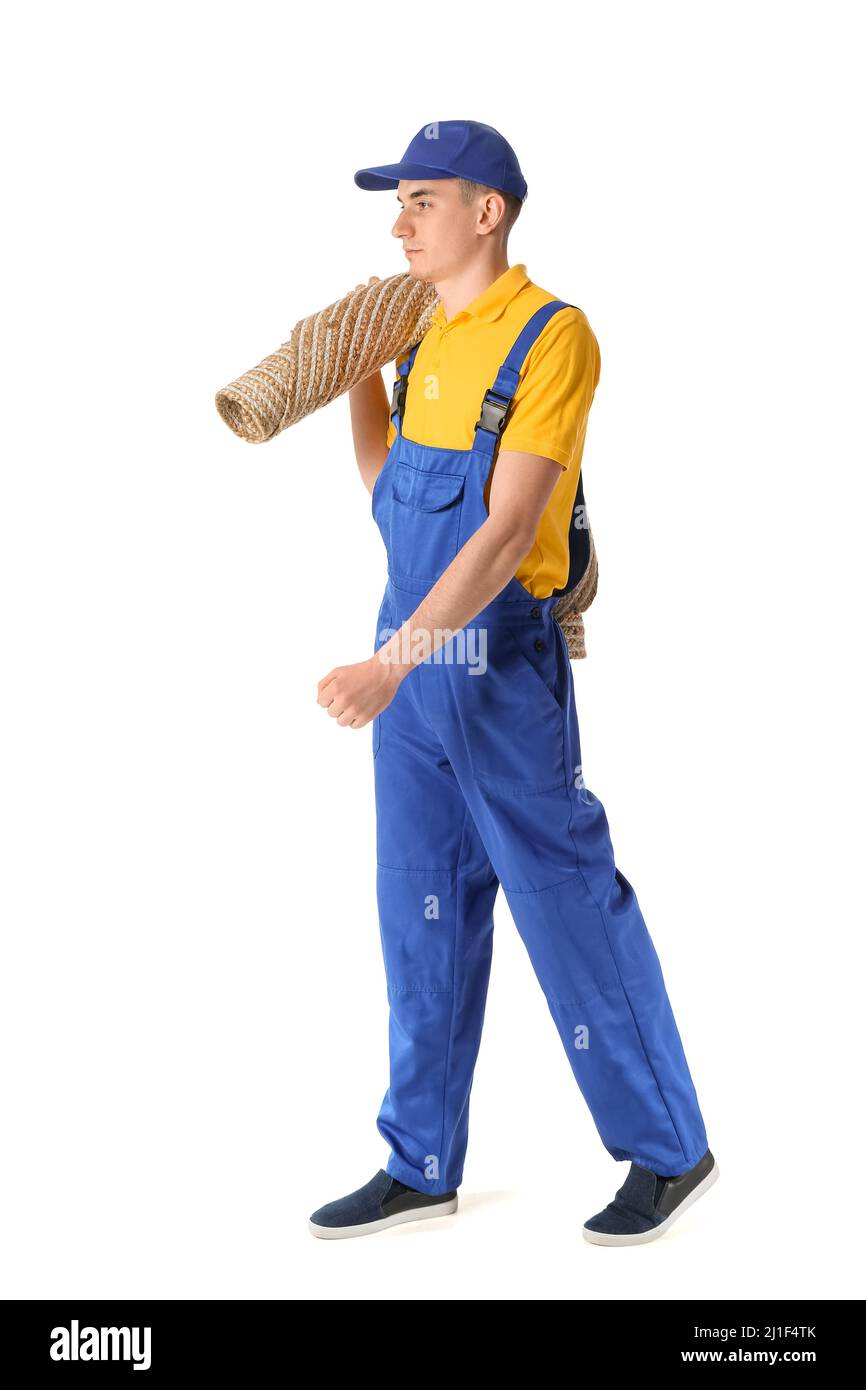 Male worker with rolled carpet on white background Stock Photo - Alamy