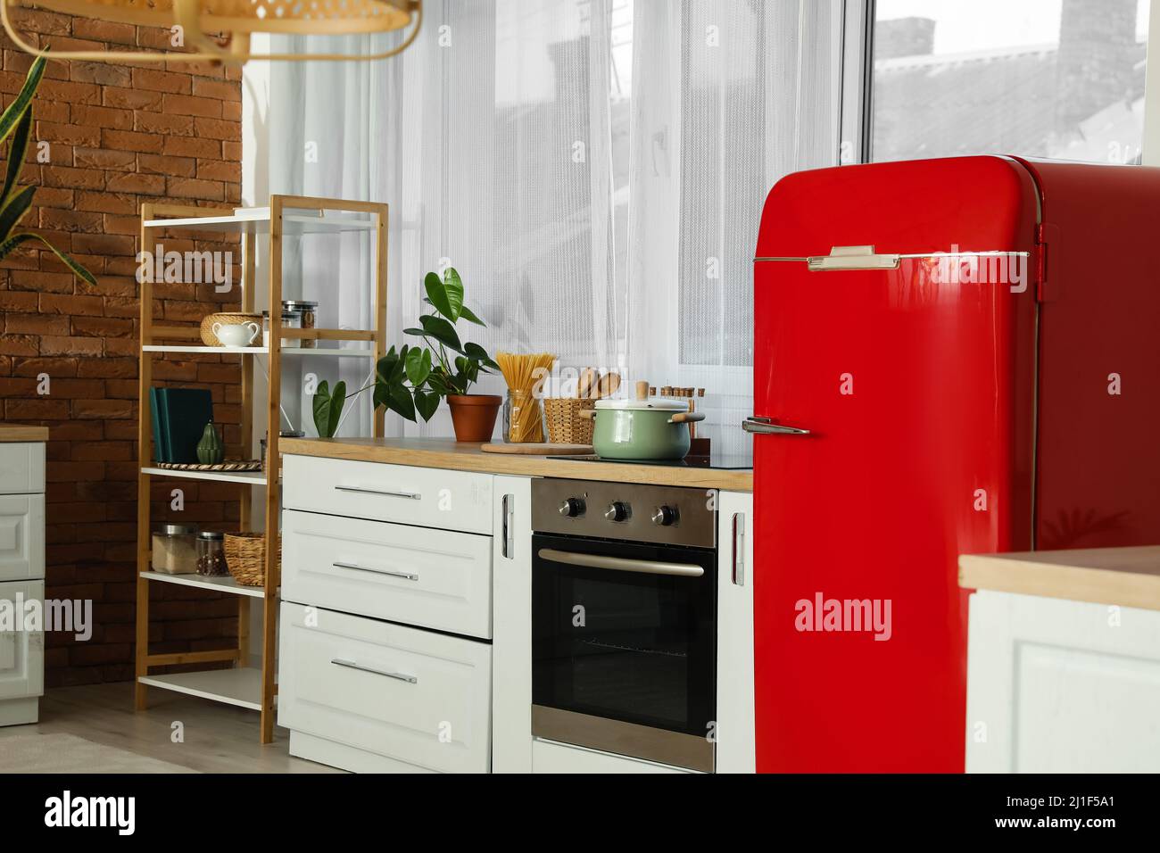 Interior of modern kitchen with red fridge and oven Stock Photo - Alamy