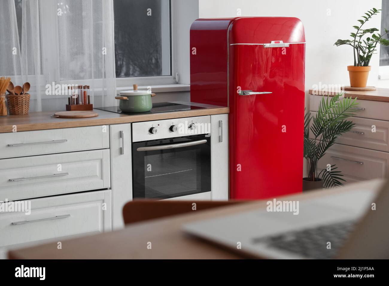 Interior of modern kitchen with red fridge and oven Stock Photo - Alamy