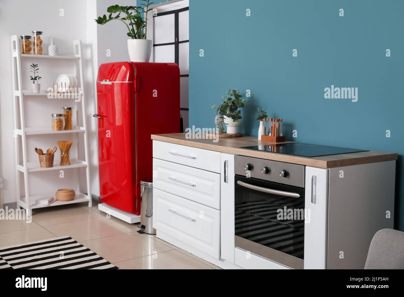 Red vintage fridge in interior of kitchen Stock Photo - Alamy